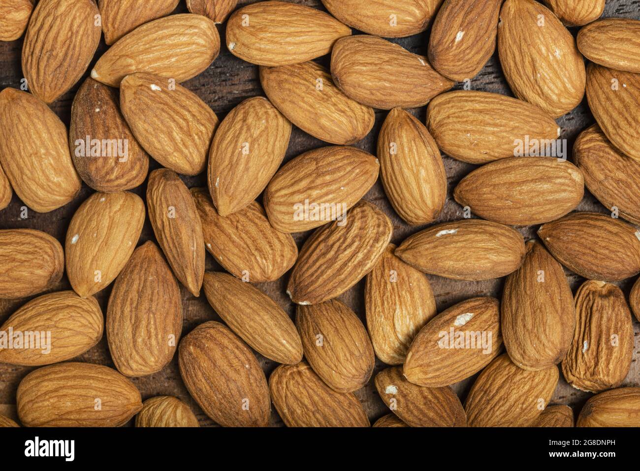 Top view of delicious almonds on a dark surface Stock Photo - Alamy
