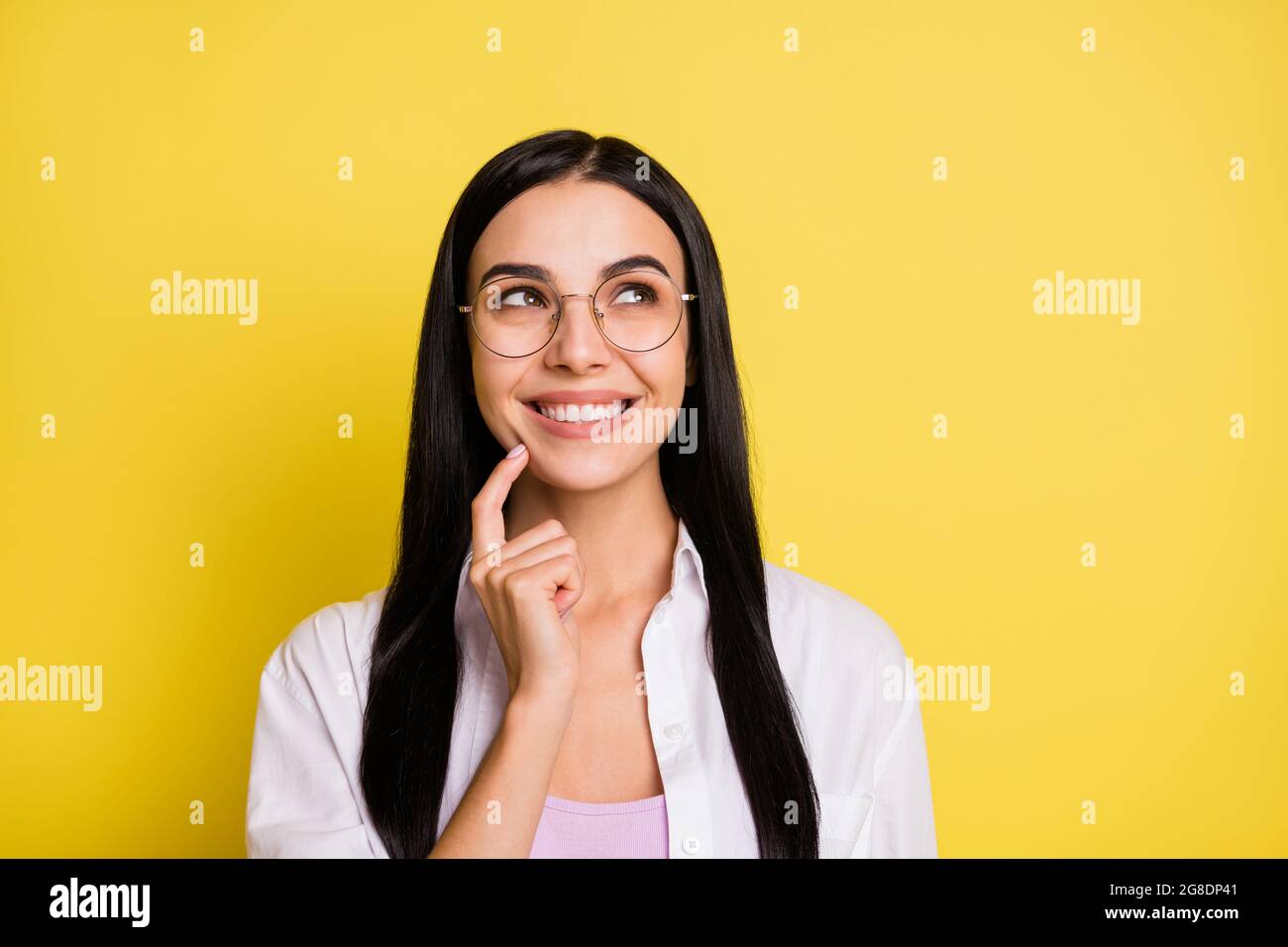 Photo of dreamy minded young woman look empty space hold finger chin ...