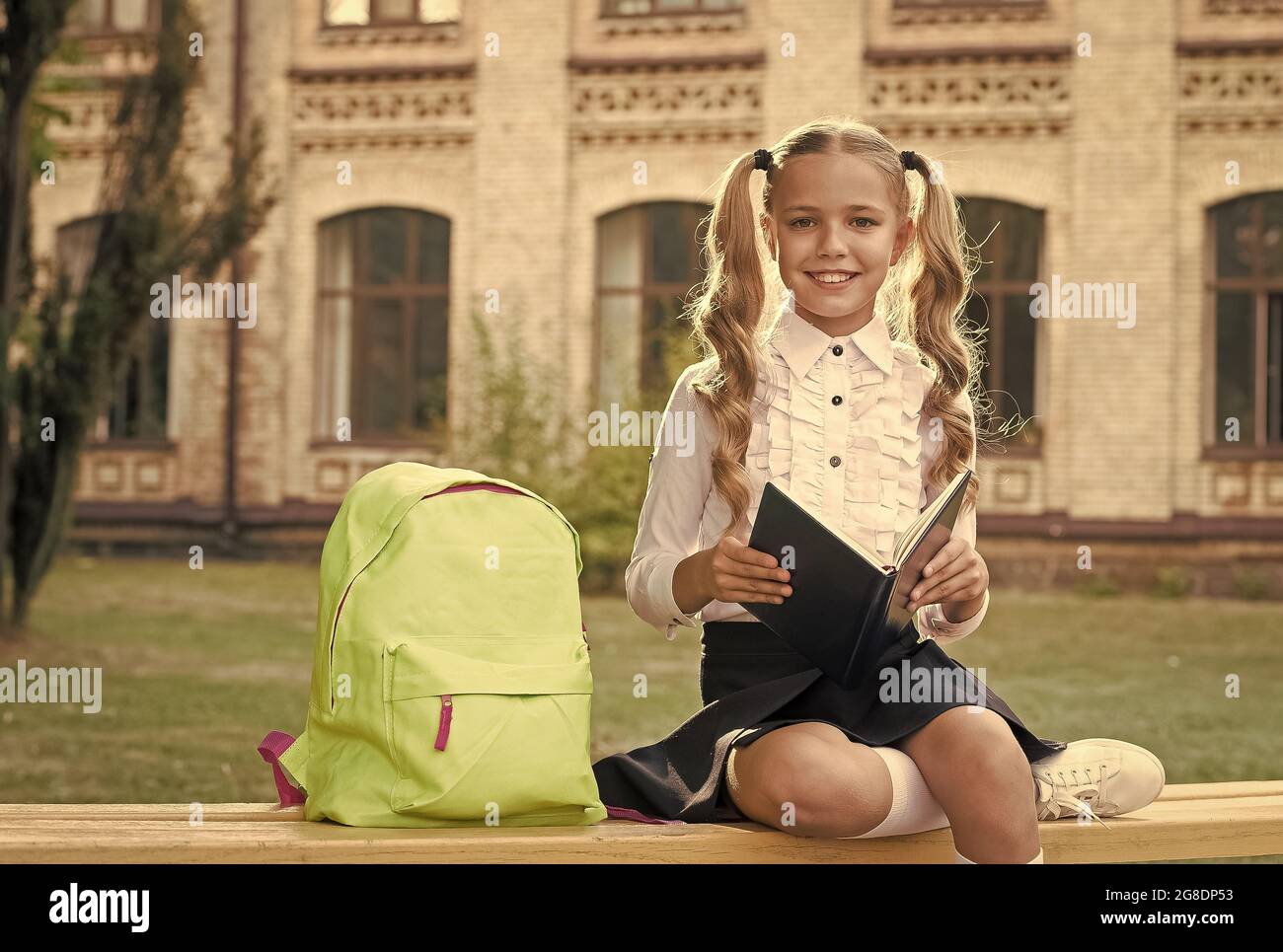 Reading makes her smarter. Little girl read library book. Small kid ...