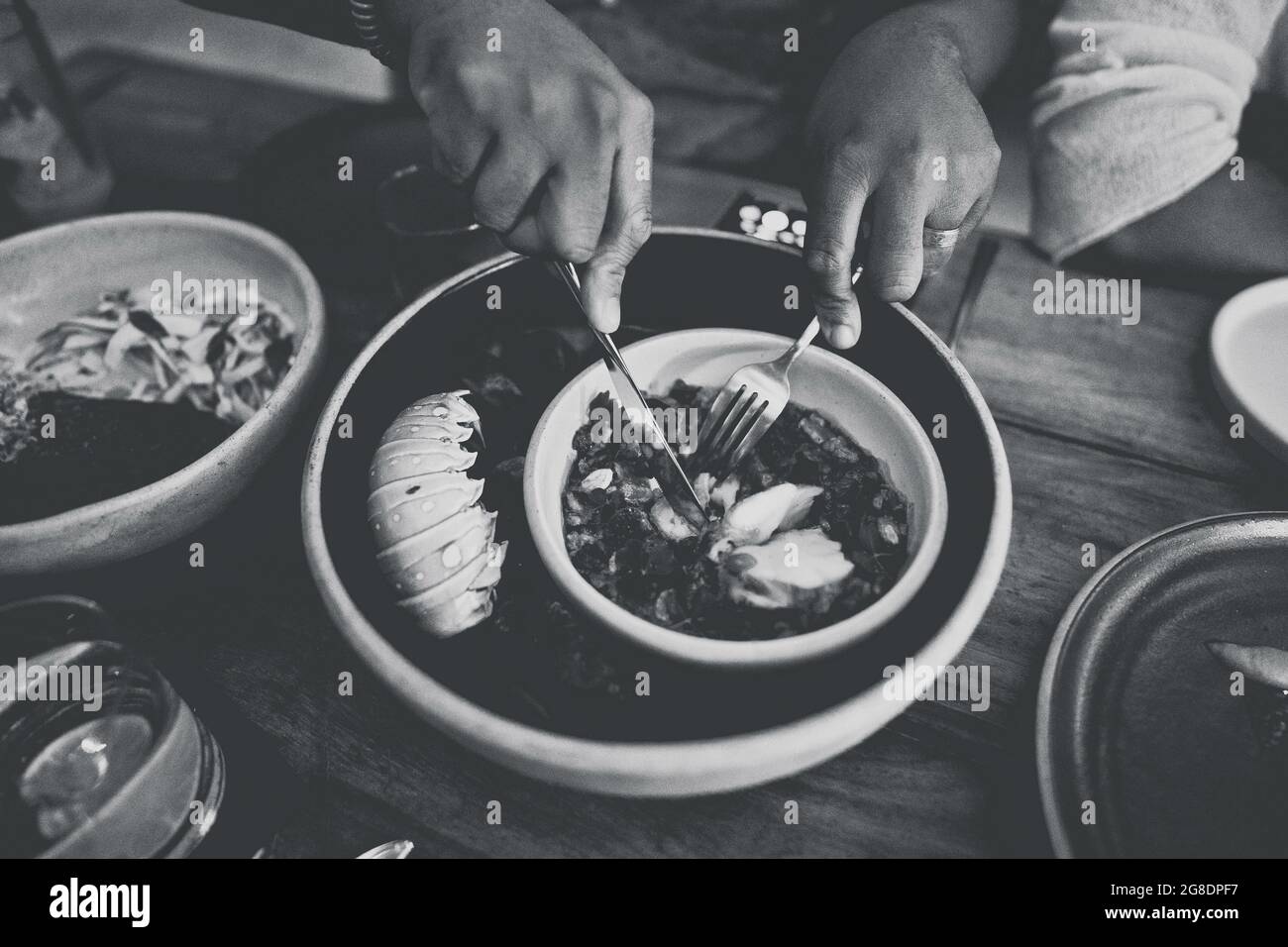 Grayscale closeup shot of a gourmet chef cutting food Stock Photo - Alamy