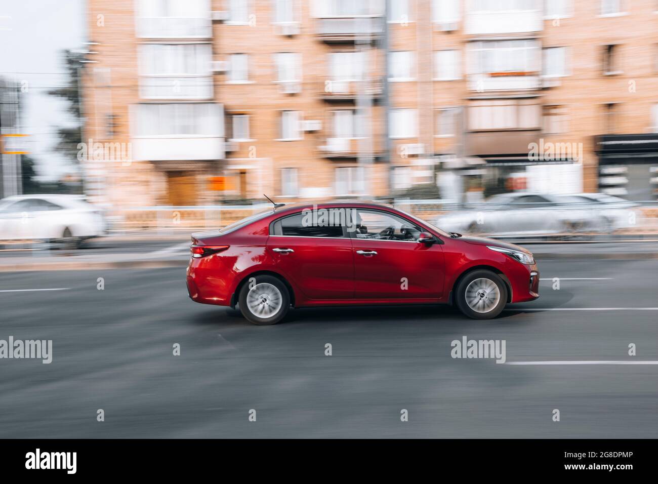 Ukraine, Kyiv - 16 July 2021: Red KIA Rio car moving on the street ...