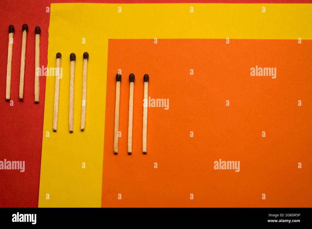 Top view of matchsticks arranged in groups of three on the red, yellow ...