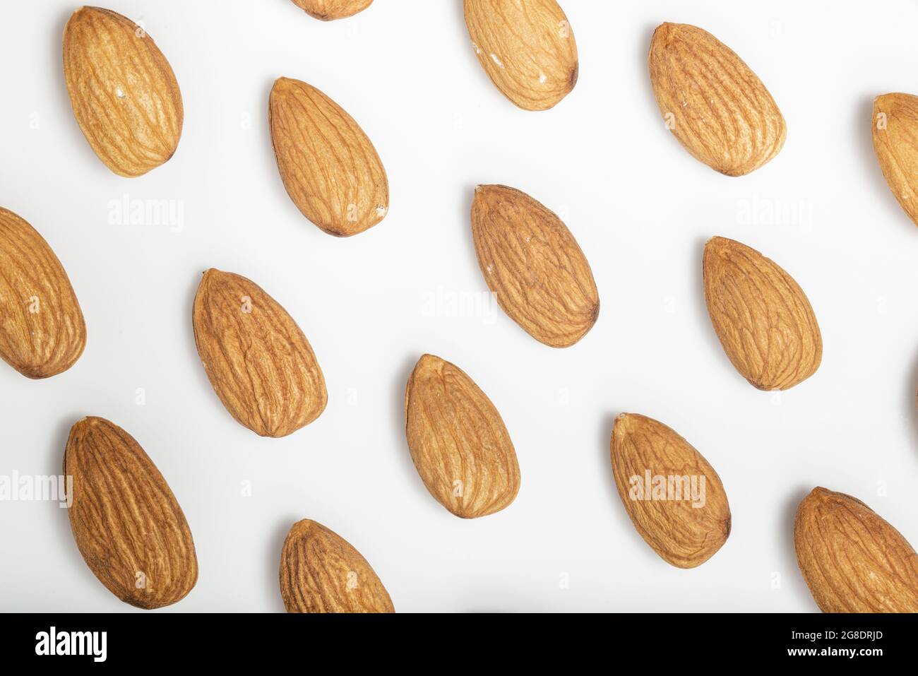 Top view of symmetrically placed almonds on an isolated white ...