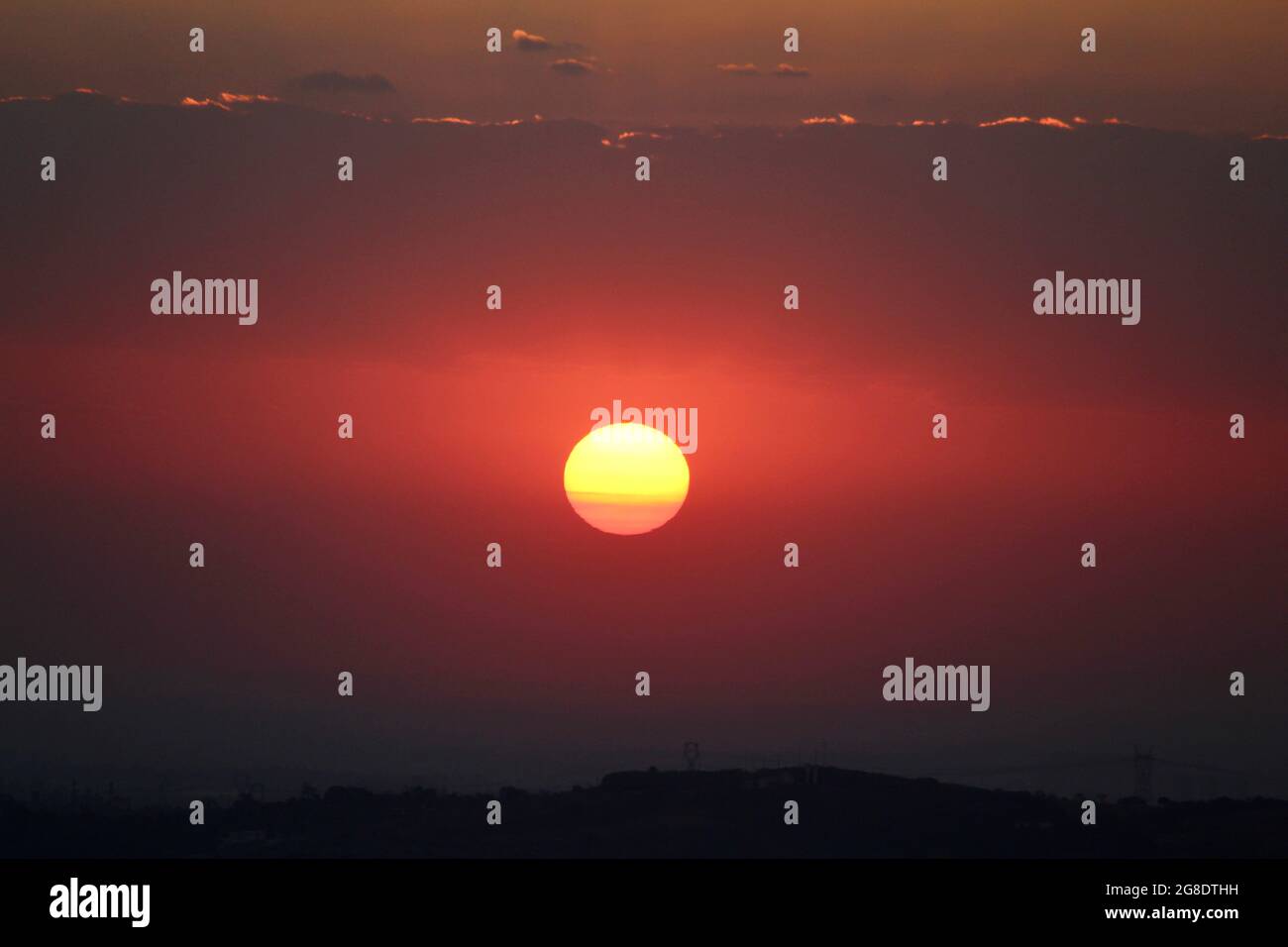 Sunset yellowish like a fireball falling on the horizon Stock Photo - Alamy