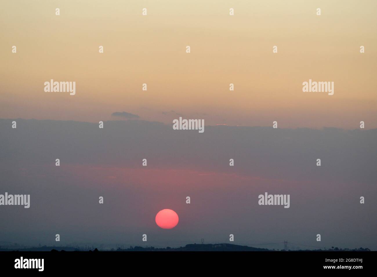 Sunset yellowish like a fireball falling on the horizon Stock Photo - Alamy