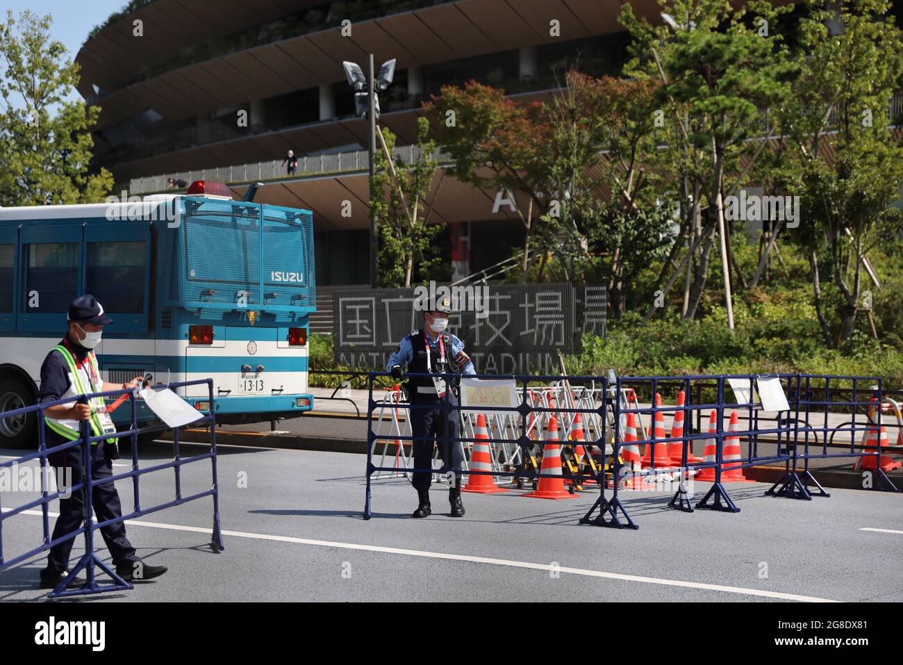 A police officer seen opening the road barricades for a car at a check ...