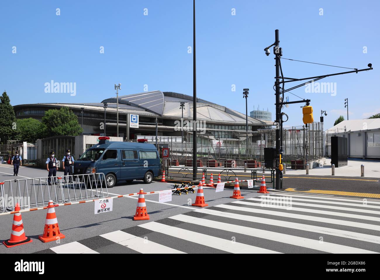 Police Officers stand guard on a closed road in front of the Tokyo ...