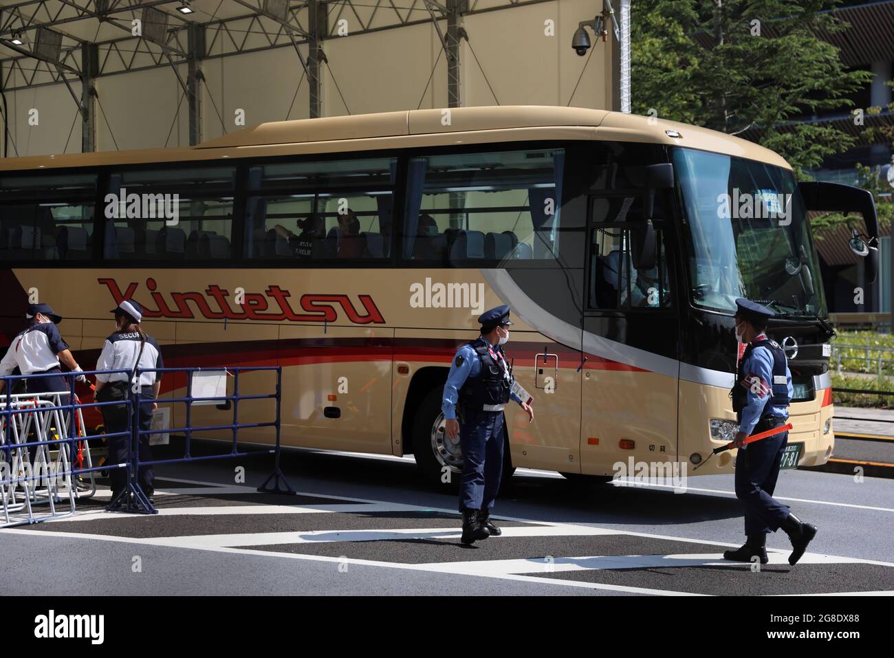 Police officers let a bus pass through a check point in front of the ...