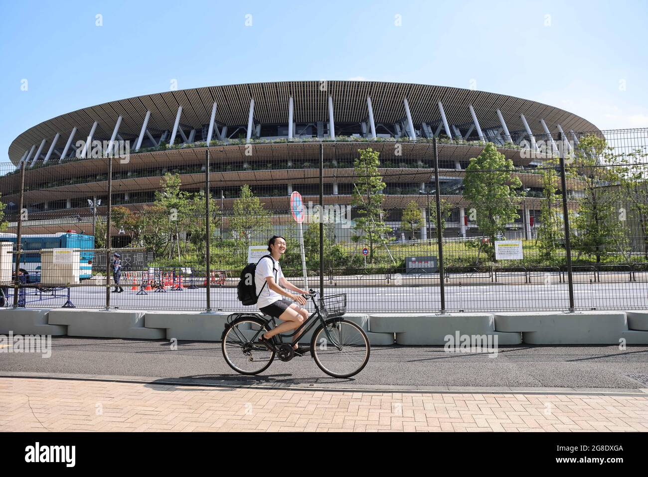 A man rides a bike past a security fence surrounding the National ...