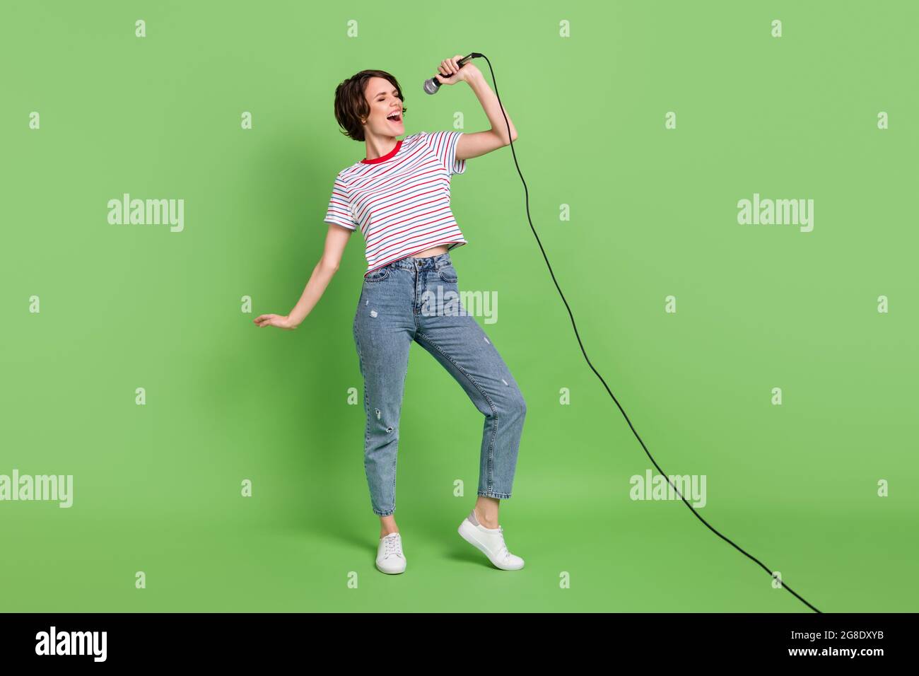 Full length body size view of pretty dreamy cheerful girl singing ...