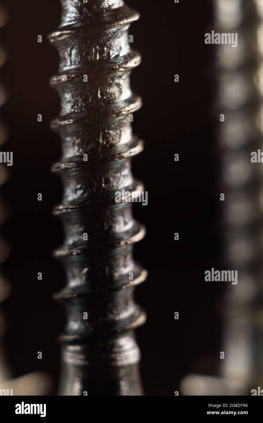 Vertical shot of different screws and bolts on a rough surface Stock ...