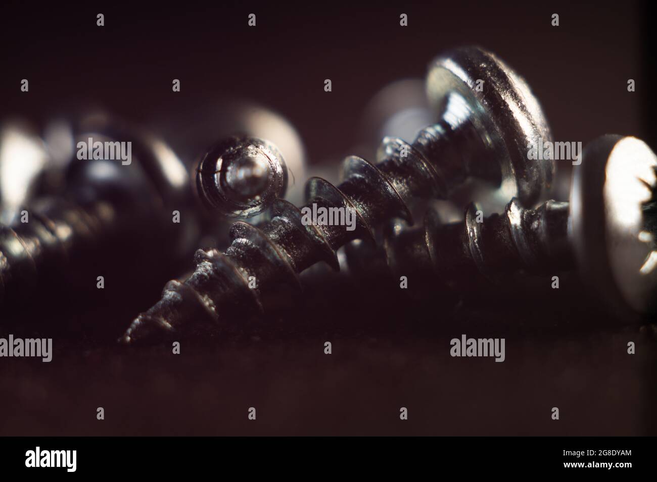 Closeup shot of different screws and bolts on a rough surface Stock ...