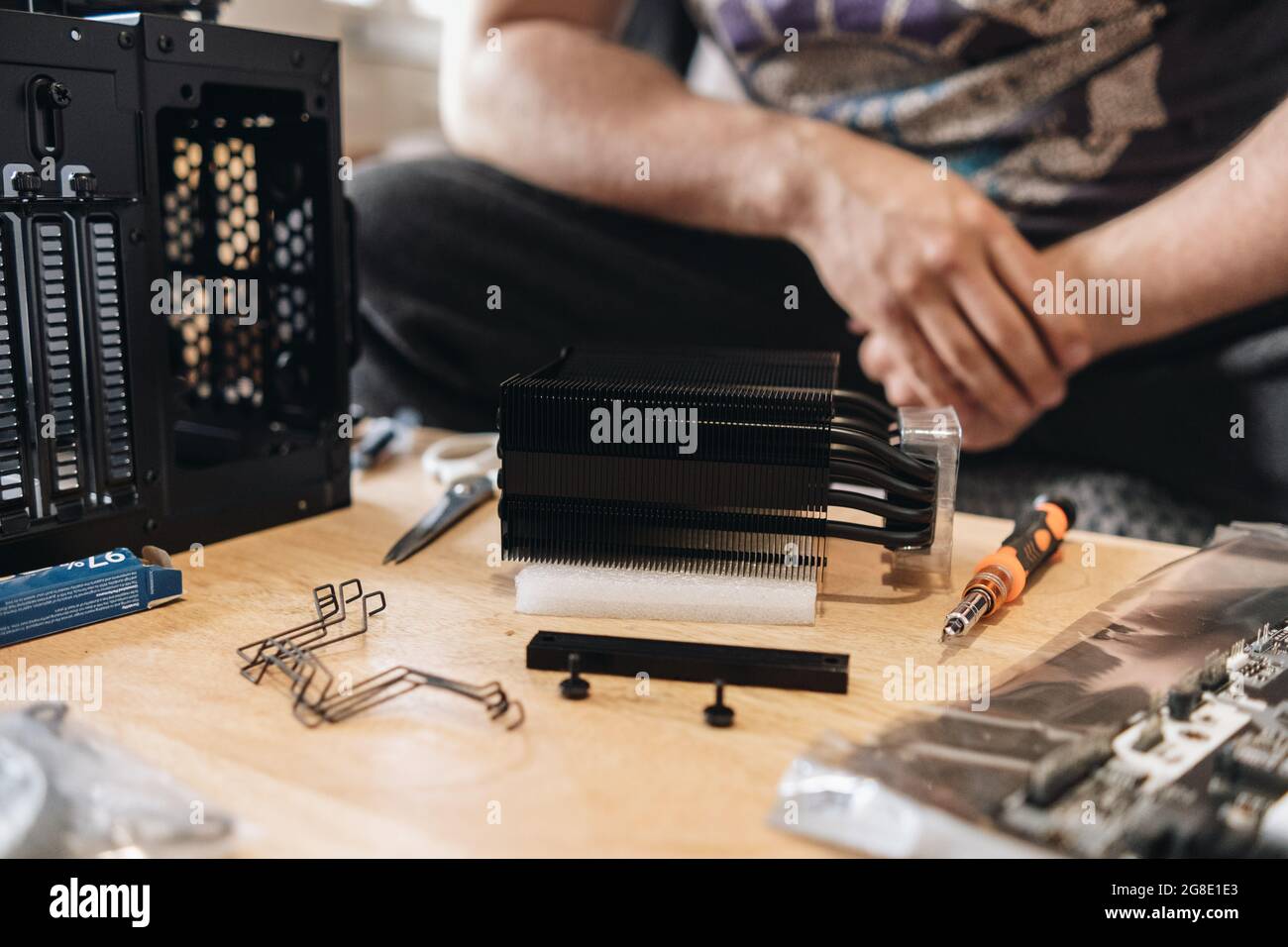 Technician sitting in front of a table with a disassembled pc Stock ...
