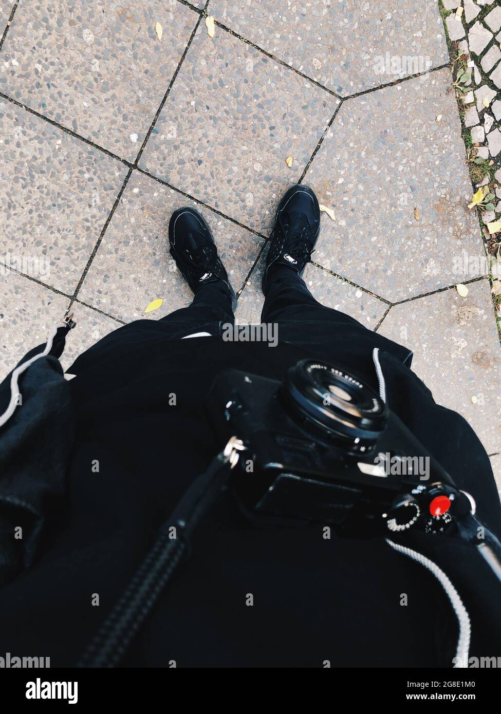 High angle shot of a tall man with a camera on a pavement Stock Photo ...