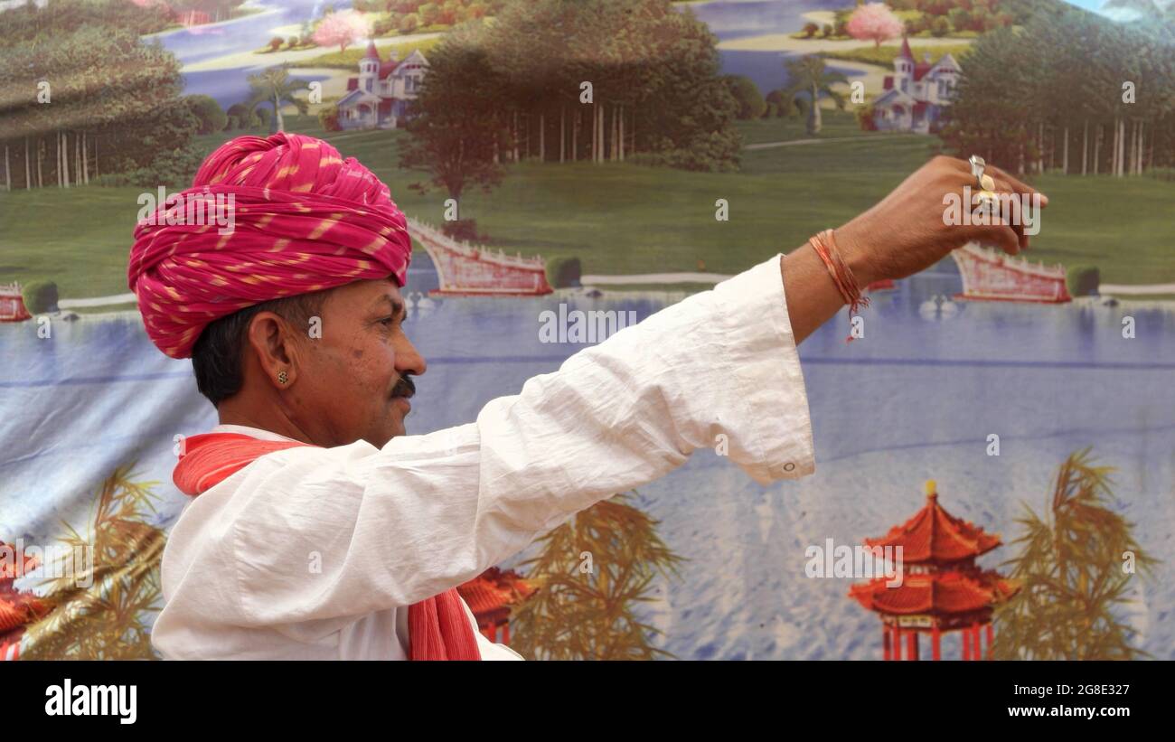 Indian male in traditional clothes with a raised hand Stock Photo - Alamy