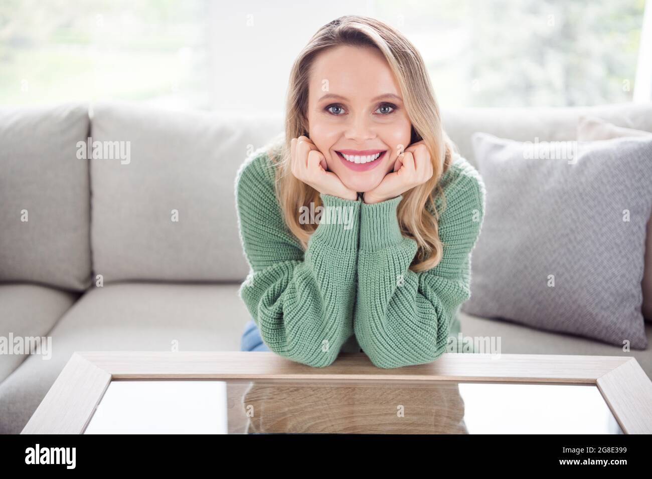 Photo of young attractive woman happy positive smile sit couch hands ...