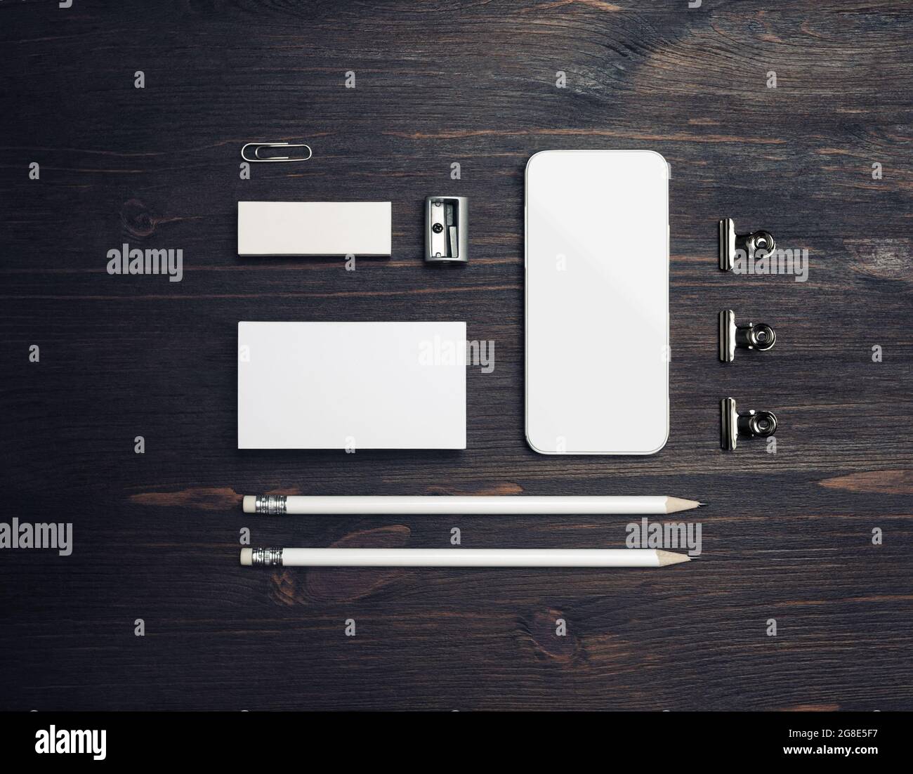 Smartphone and stationery: blank business card, pencils, eraser and ...