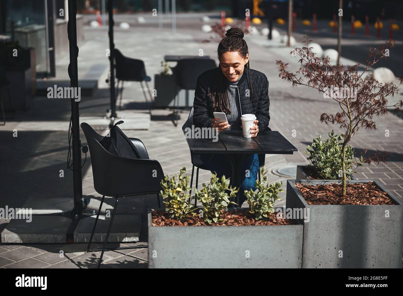 Spacious cafe terrace with only one visitor Stock Photo - Alamy