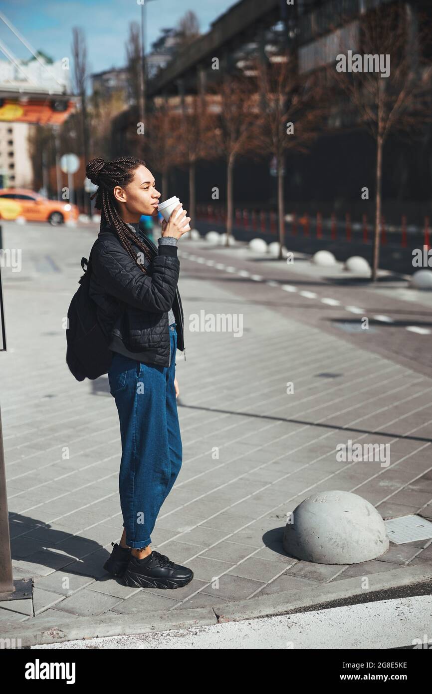 Taking sip of coffee while waiting for friend Stock Photo - Alamy