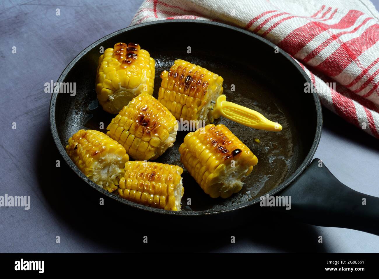 Fried corn on the corn cob in pan, sweet corn, Germany Stock Photo - Alamy