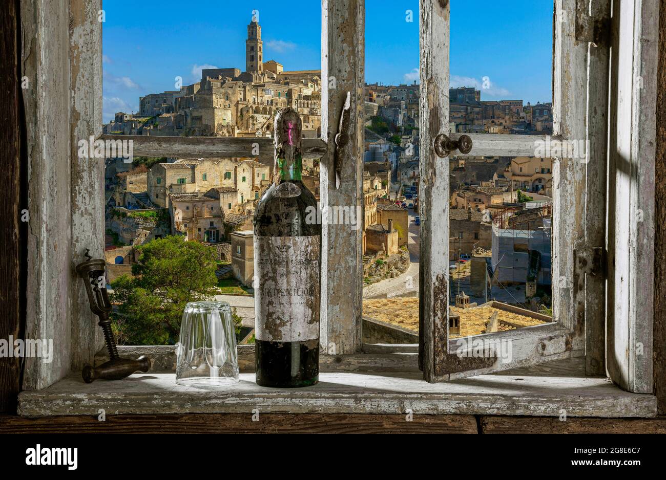 Farmhouse, old bottle of red wine, glass, corkscrew, view from open ...