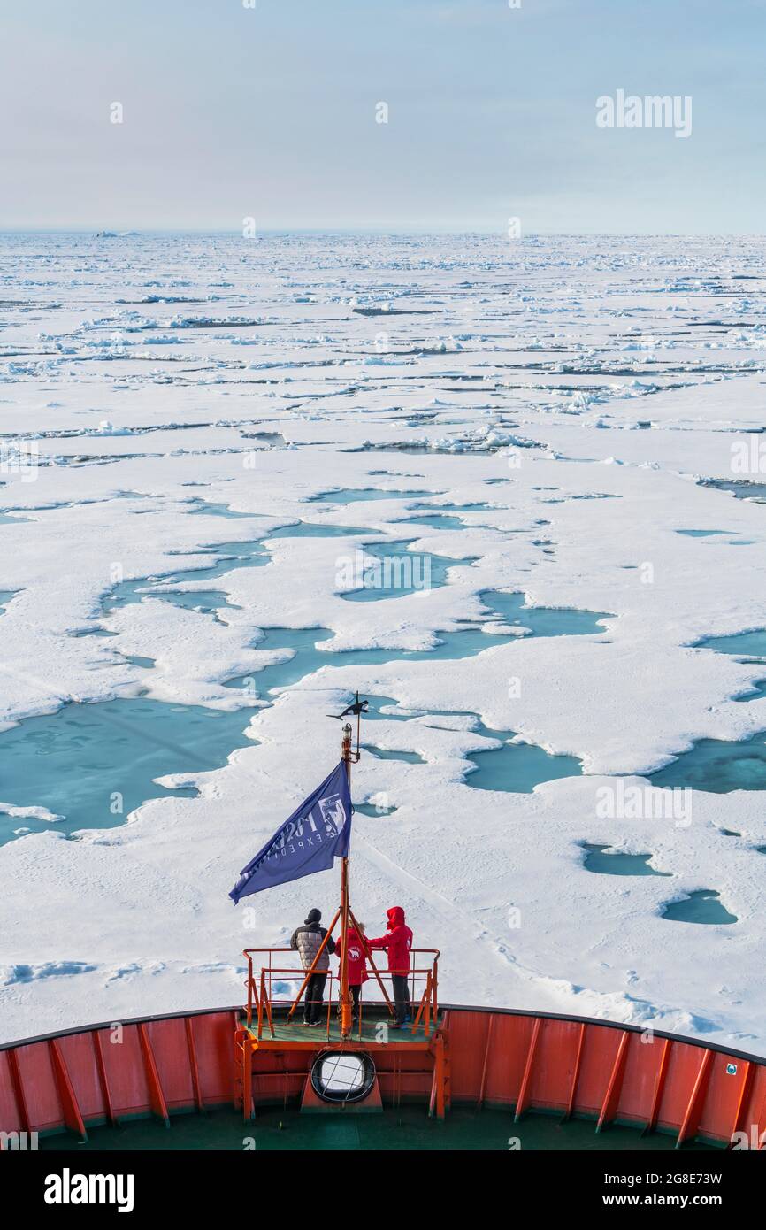 Tourists watching the ice breaking on board of an icebreaker, North ...