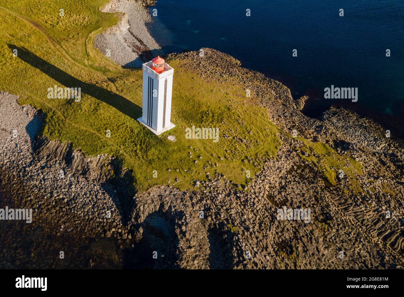 Lighthouse and coastal landscape with basalt formations, Kalfshamarsvik ...