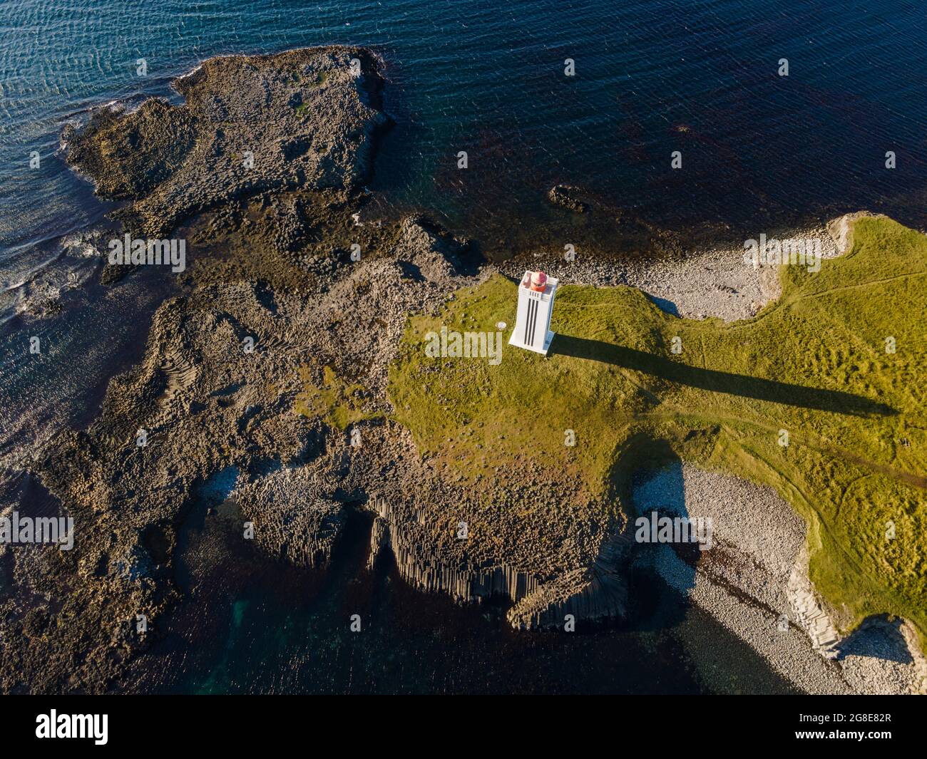 Lighthouse and coastal landscape with basalt formations, Kalfshamarsvik ...