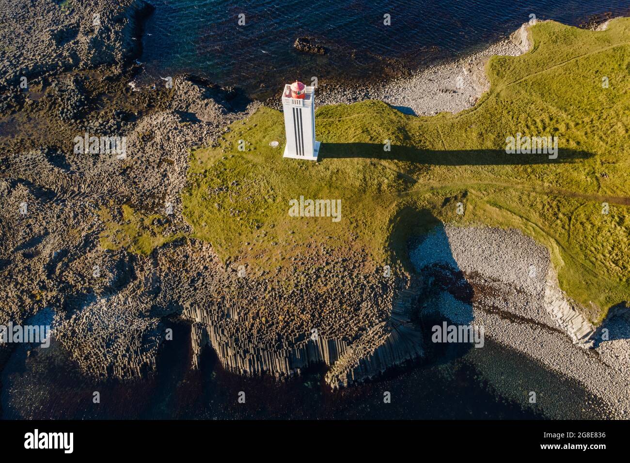 Lighthouse and coastal landscape with basalt formations, Kalfshamarsvik ...