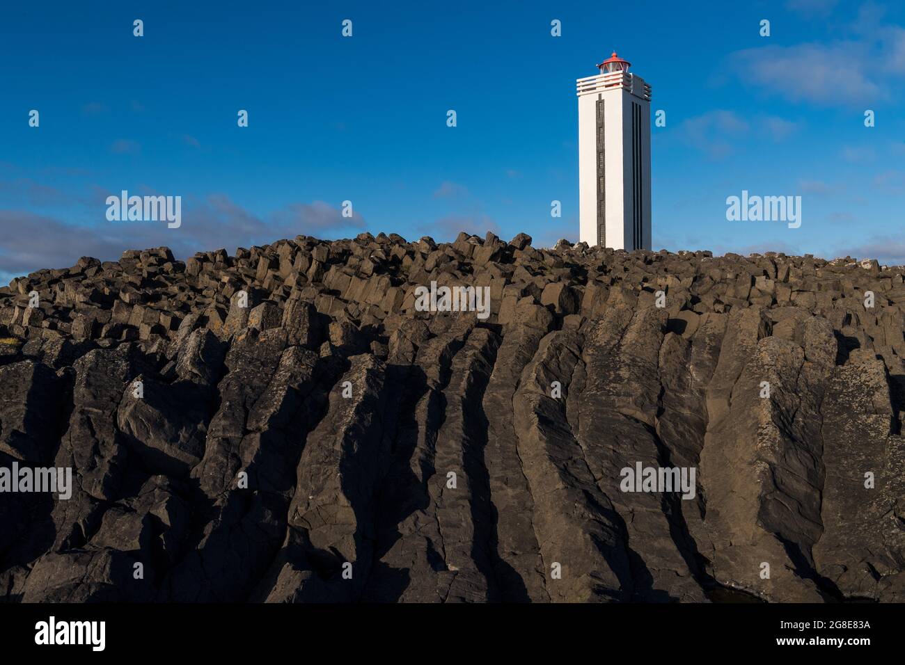 Lighthouse and coastal landscape with basalt formations, Kalfshamarsvik ...