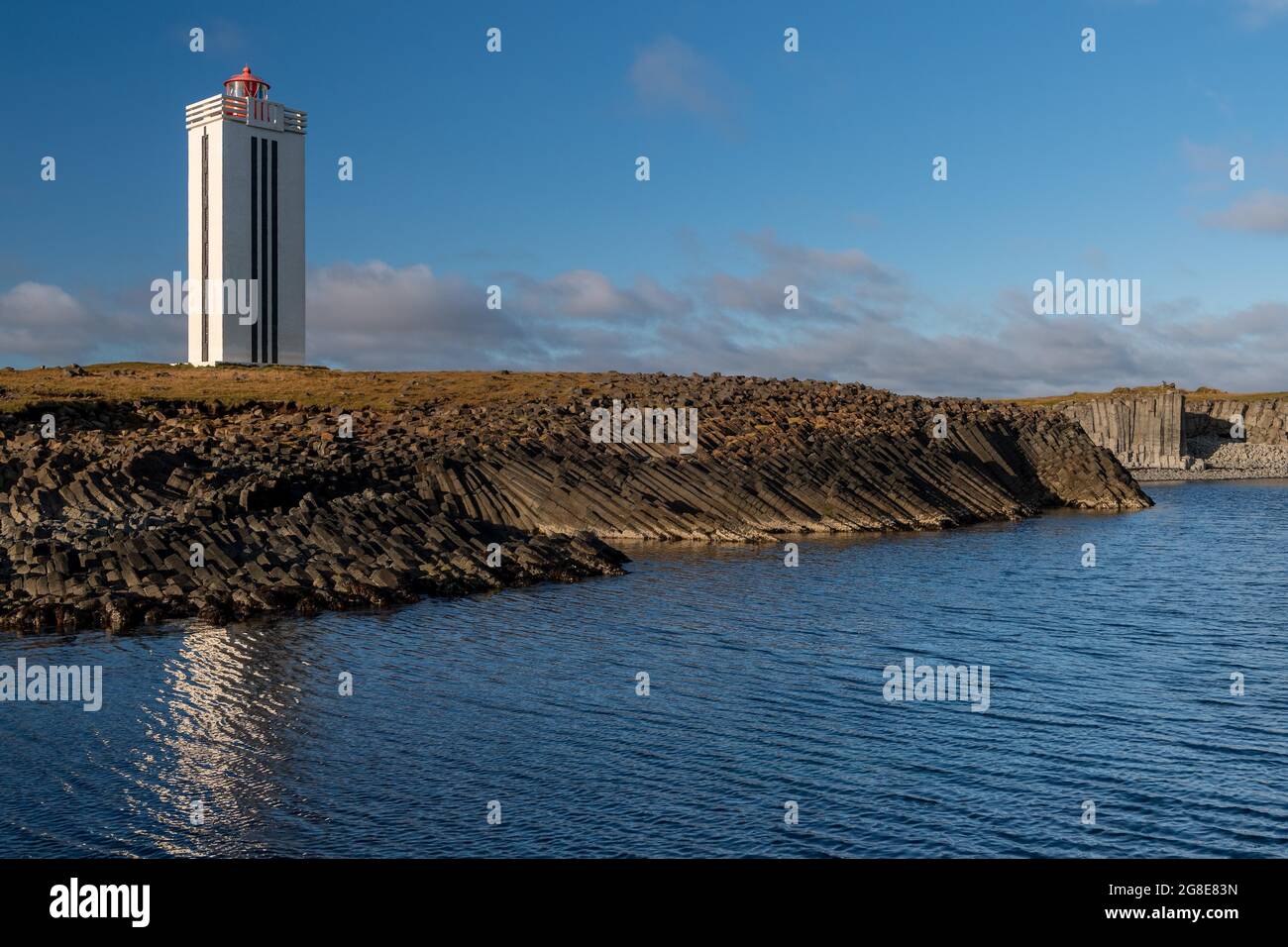 Lighthouse and coastal landscape with basalt formations and basalt ...