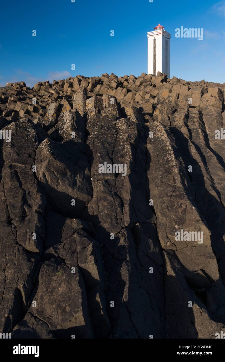 Lighthouse and coastal landscape with basalt formations, Kalfshamarsvik ...