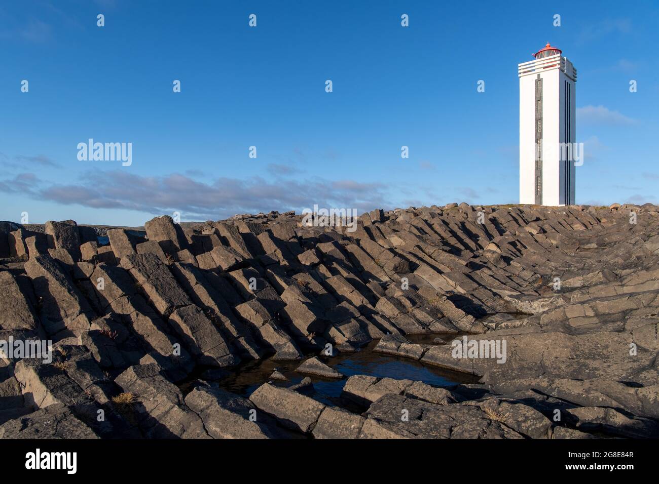 Lighthouse and coastal landscape with basalt formations, Kalfshamarsvik ...