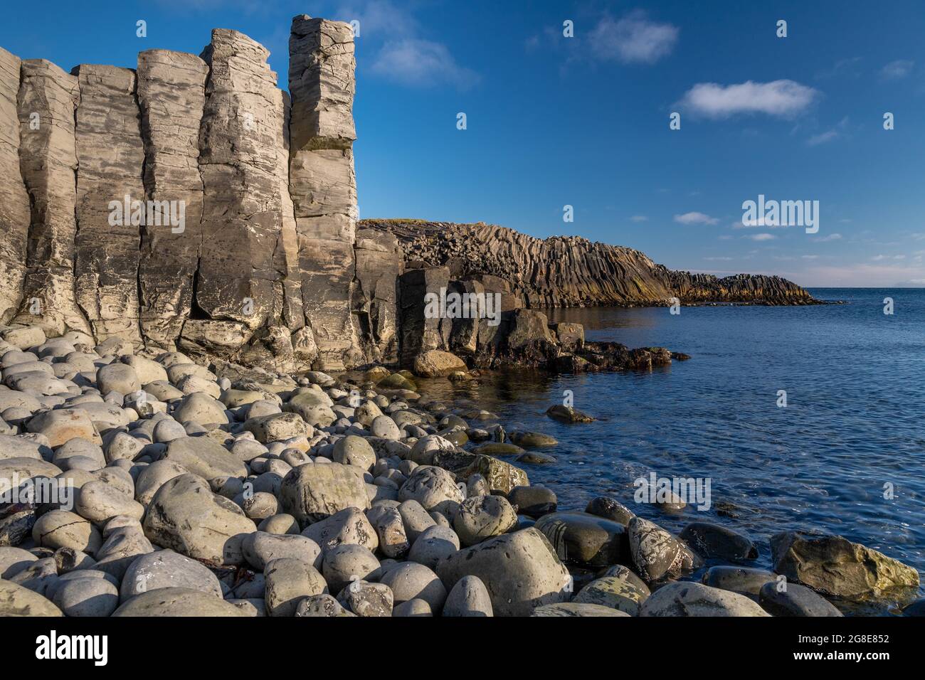 Rounded stones on the beach, basalt cliff, Kalfshamarsvik, Skagi ...