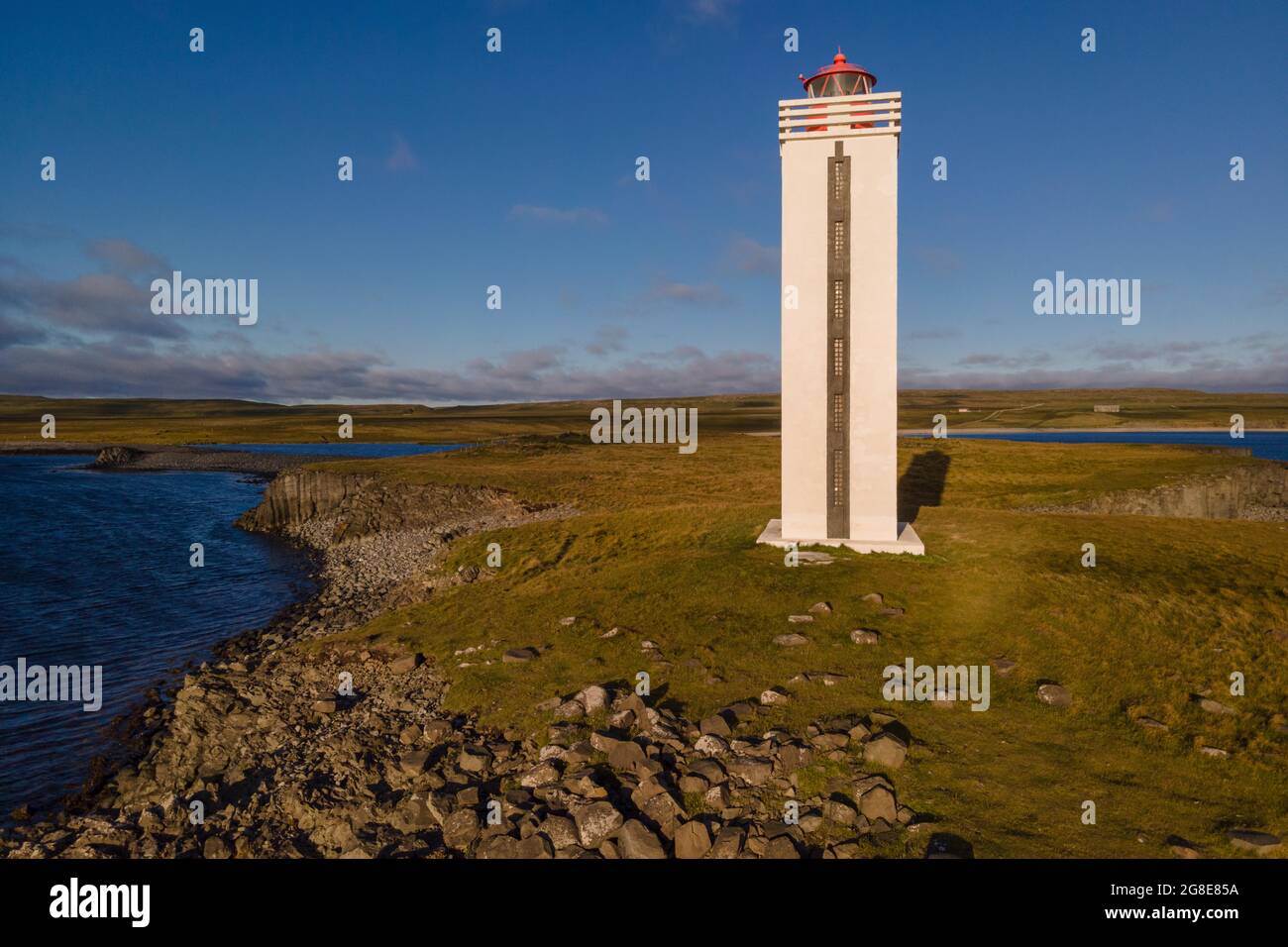Lighthouse and coastal landscape with basalt formations, Kalfshamarsvik ...