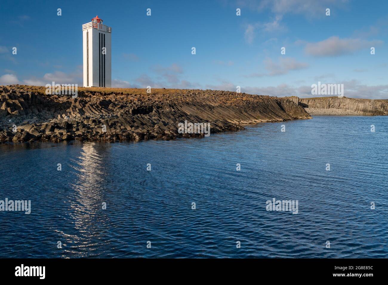 Lighthouse and coastal landscape with basalt formations and basalt ...