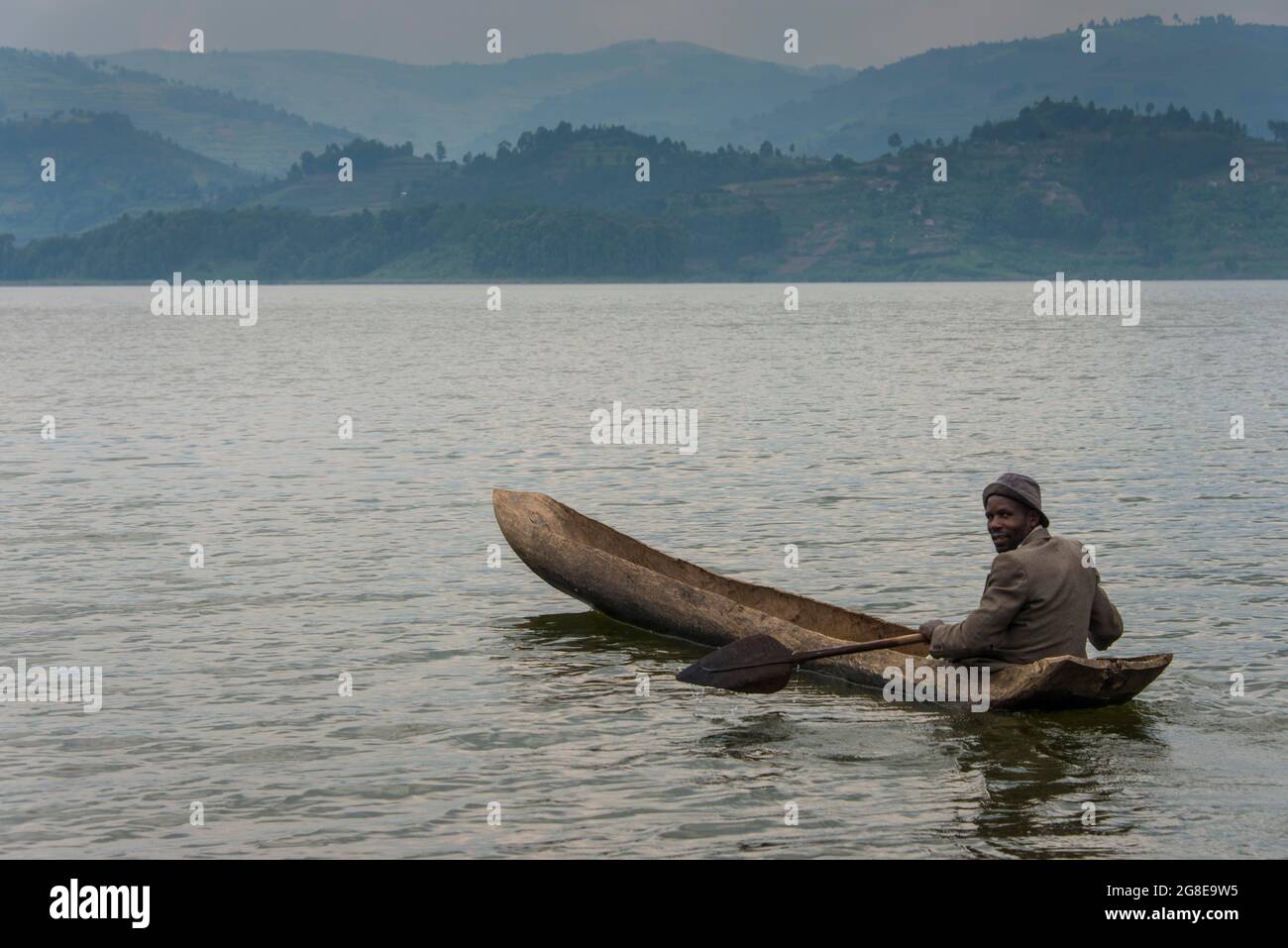 Local in a dugout canoe, Lake Bunyonyi, Uganda, Africa Stock Photo - Alamy