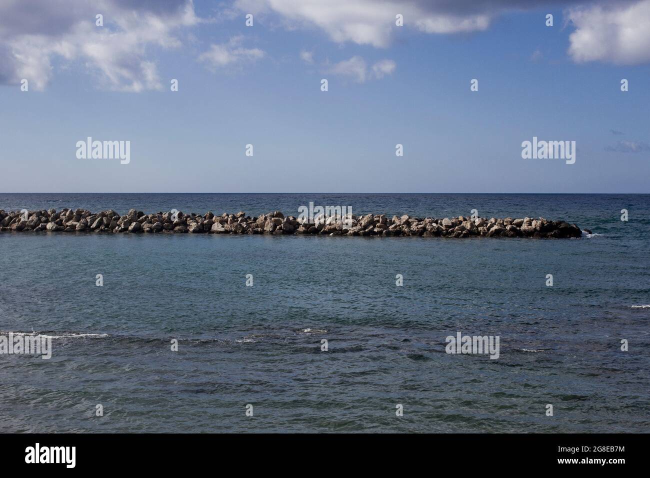 A harbour breakwater made of rocks on the island of Crete, Greece Stock ...