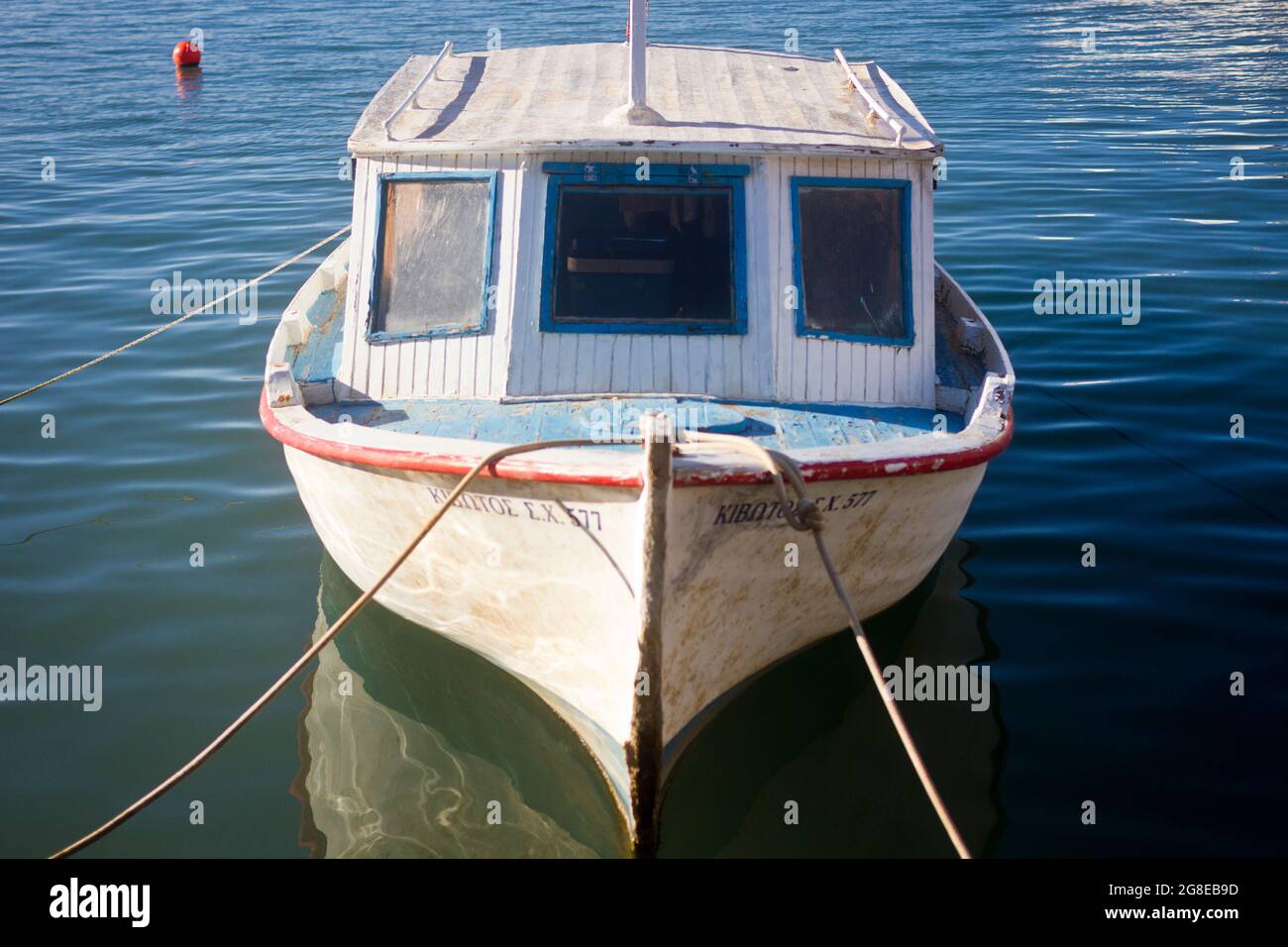 A small boat at anchor in Chania's Old Venetian Harbour on the island ...
