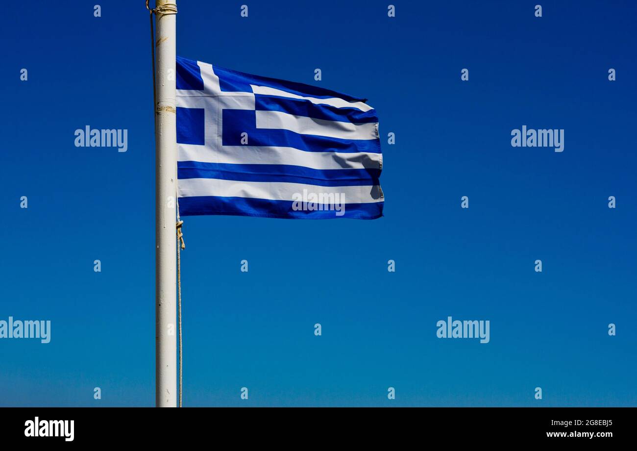 The Greek flag flying in the wind on the island of Crete, Greece Stock ...