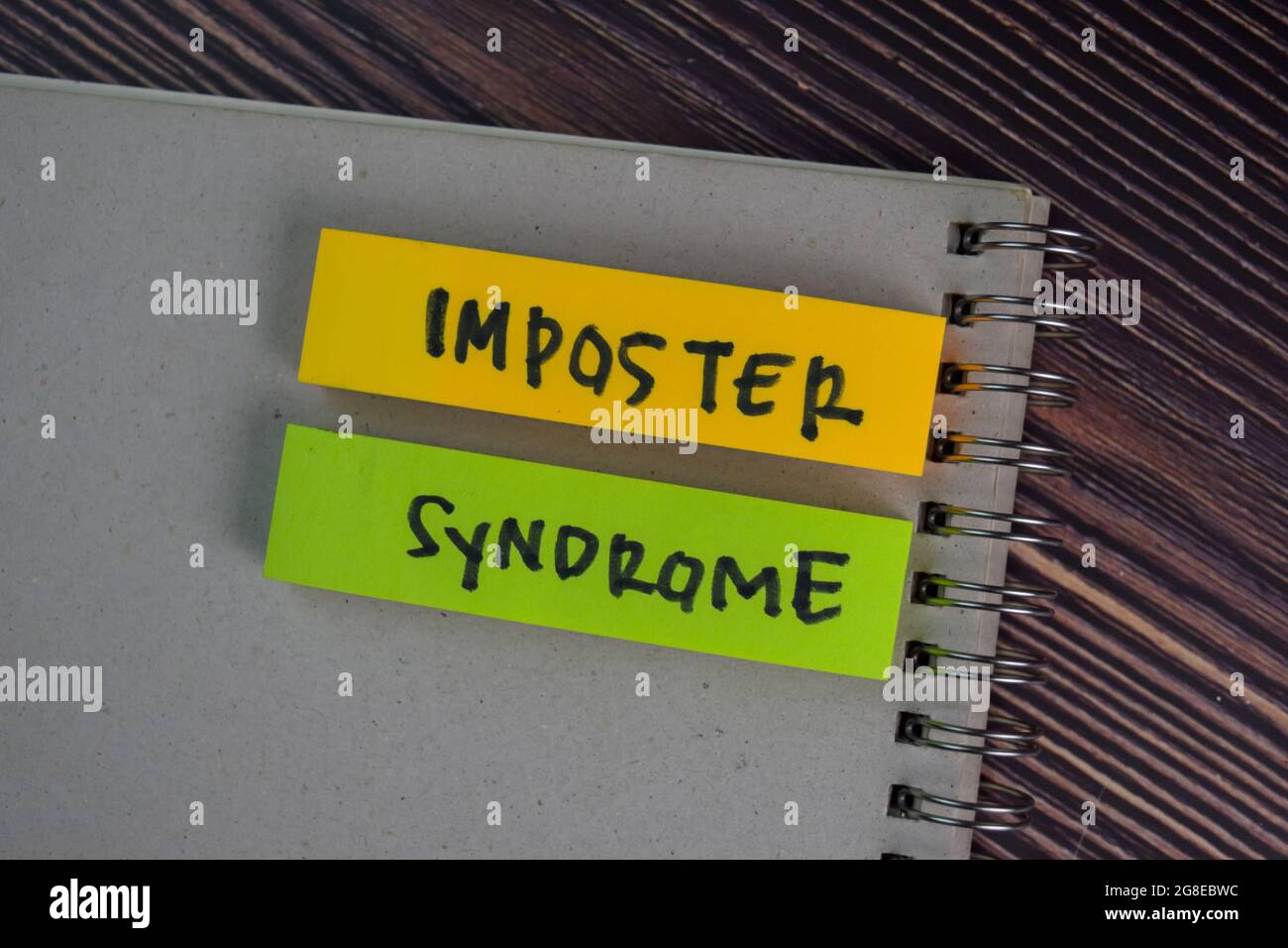 Imposter Syndrome write on sticky notes isolated on Wooden Table Stock ...