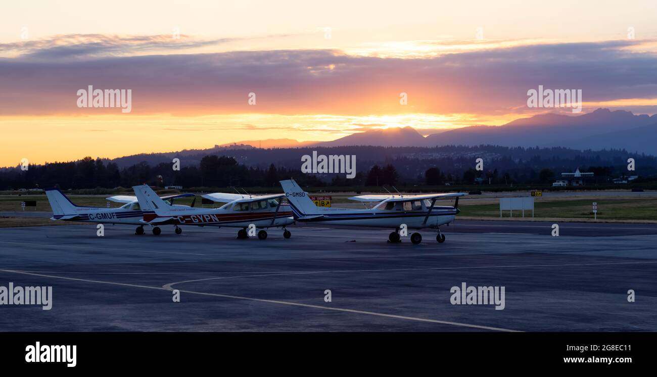 Cessna Airplanes parked at an Airport during a colorful summer sunset ...