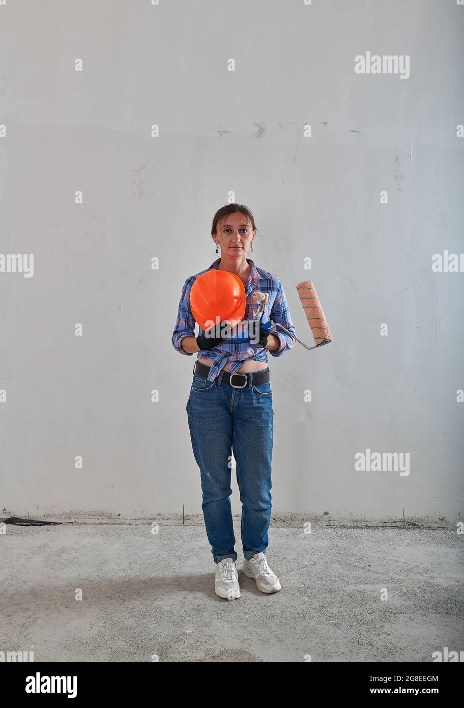 tortured painter in orange helmet and roller Stock Photo - Alamy