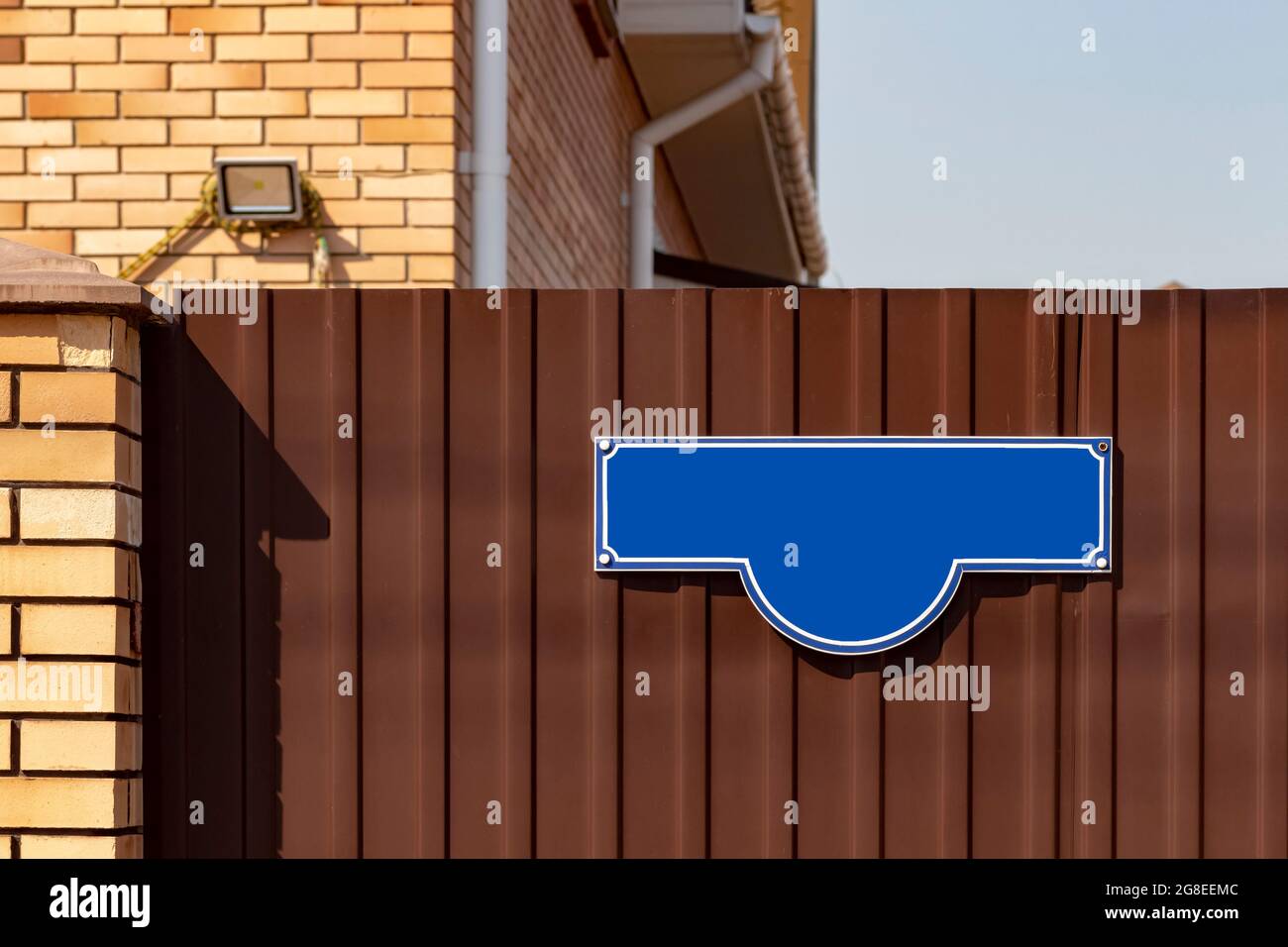 A blue address sign on the fence of a private house Stock Photo - Alamy