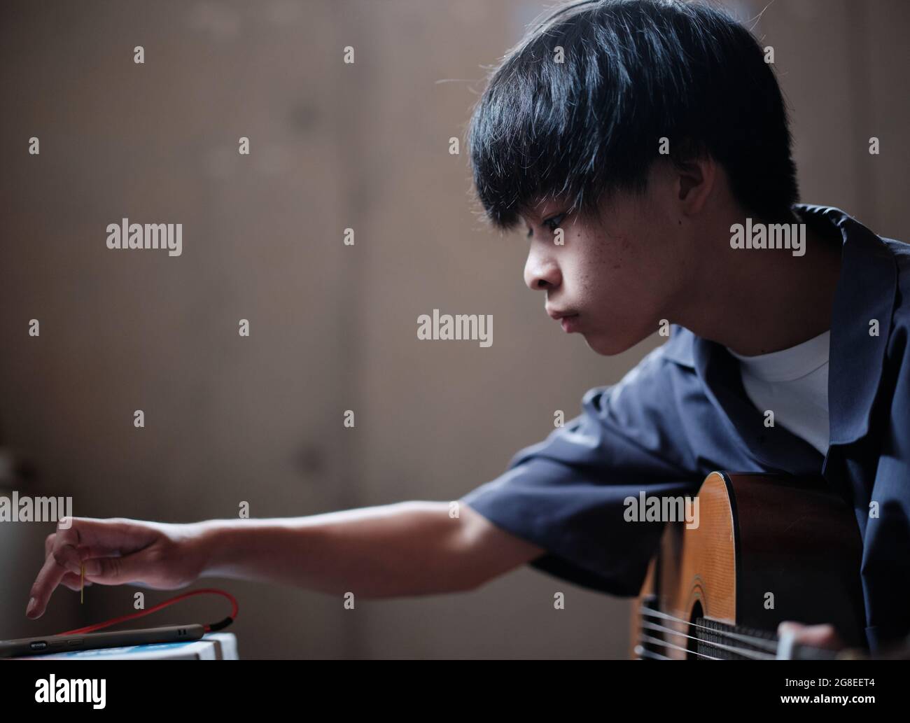 Asian boy playing guitar hi-res stock photography and images - Alamy