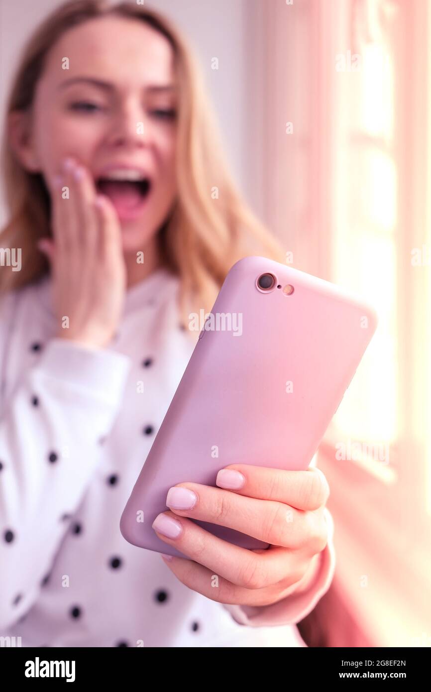 Blonde young girl taking selfie. Video call. Online education. Work ...