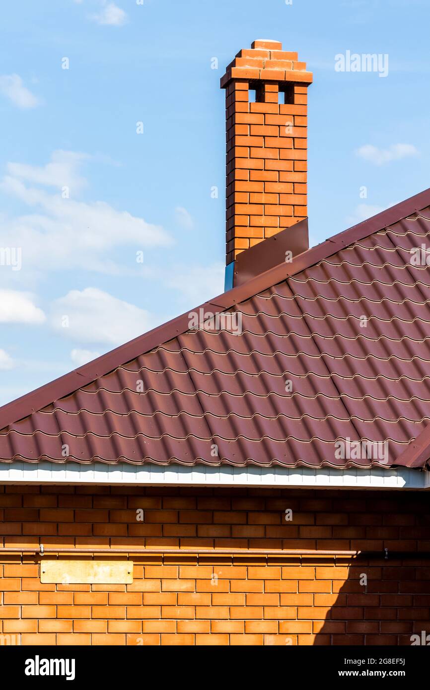 Brick pipe on the roof of a private house Stock Photo - Alamy