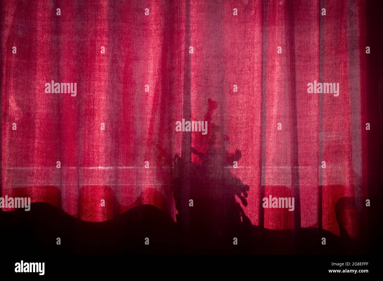 Sunlight breaks through thick red room curtains Stock Photo - Alamy