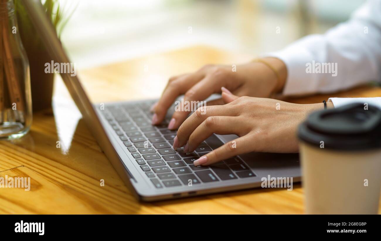 Cropped shot of college student doing work assignment via smart laptop ...
