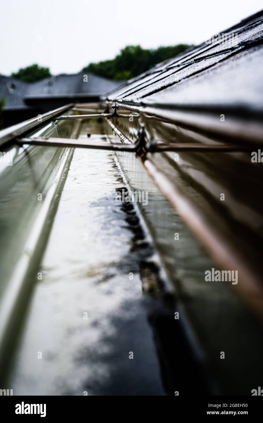 Selective focus on a section of residential guttering with hanger ...